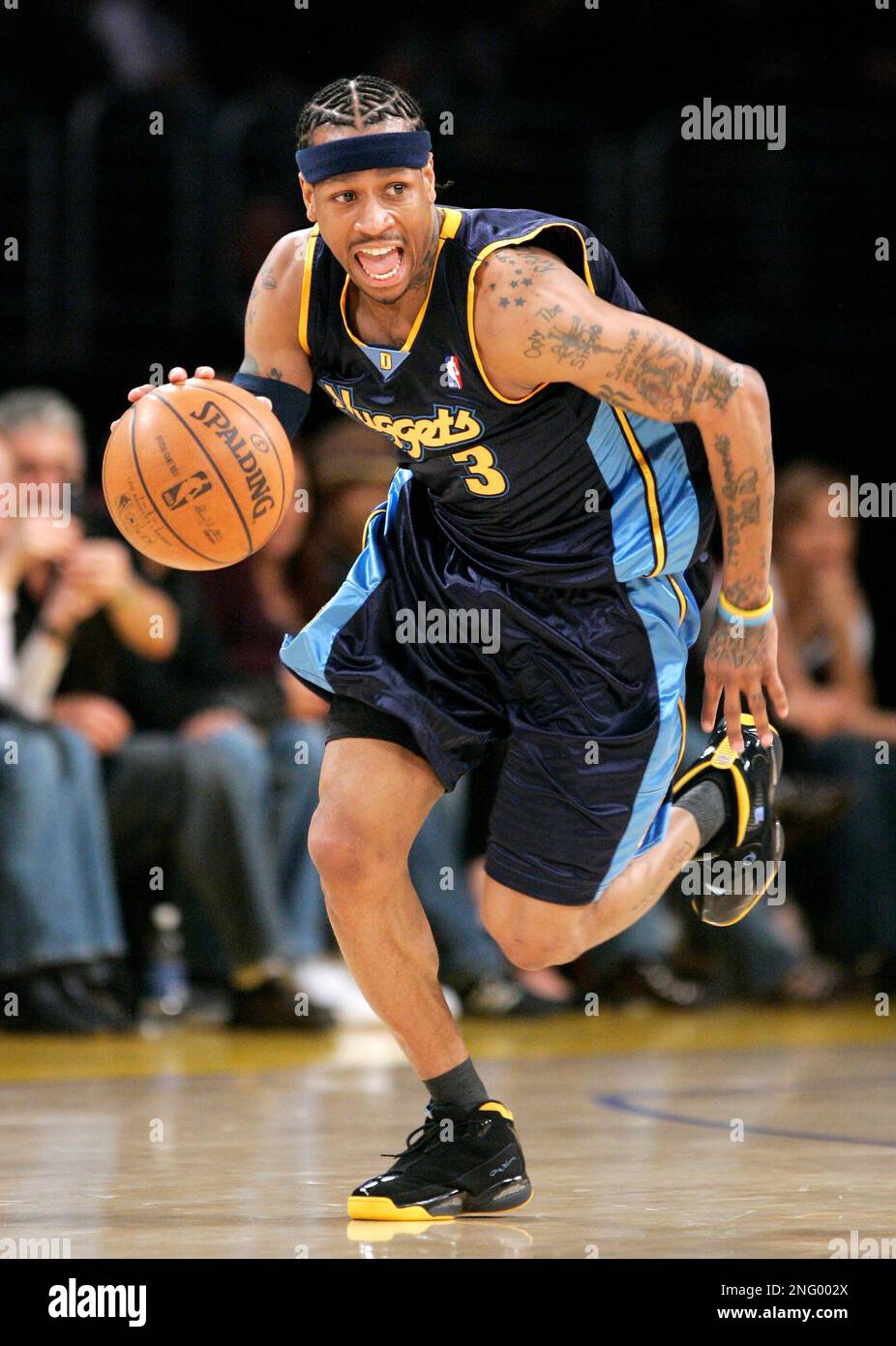 Denver Nuggets guard Allen Iverson moves the ball down court during the ...
