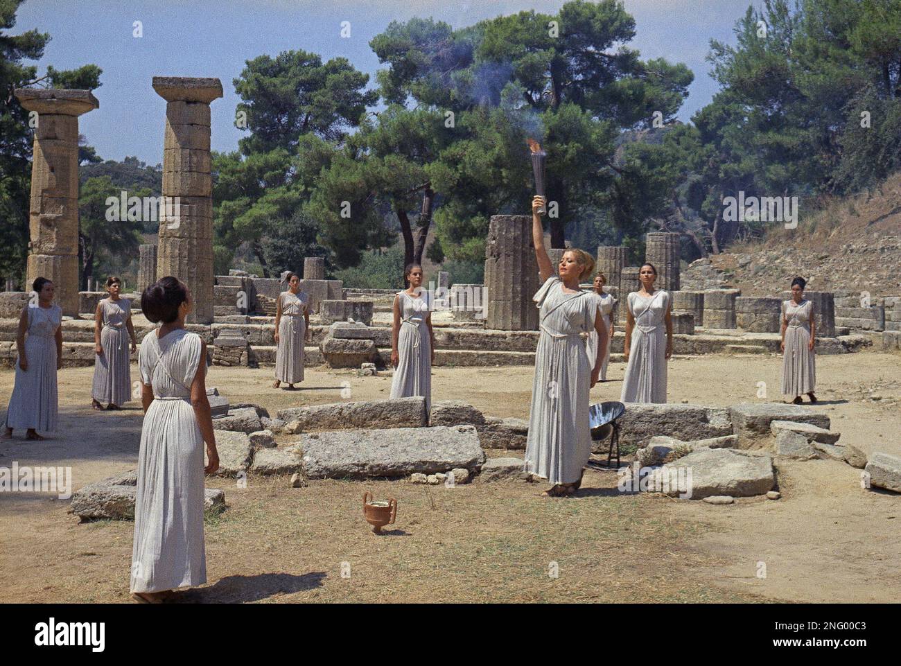 Seen here is the chief priestess, Maria Moscholiou as she lights the ...