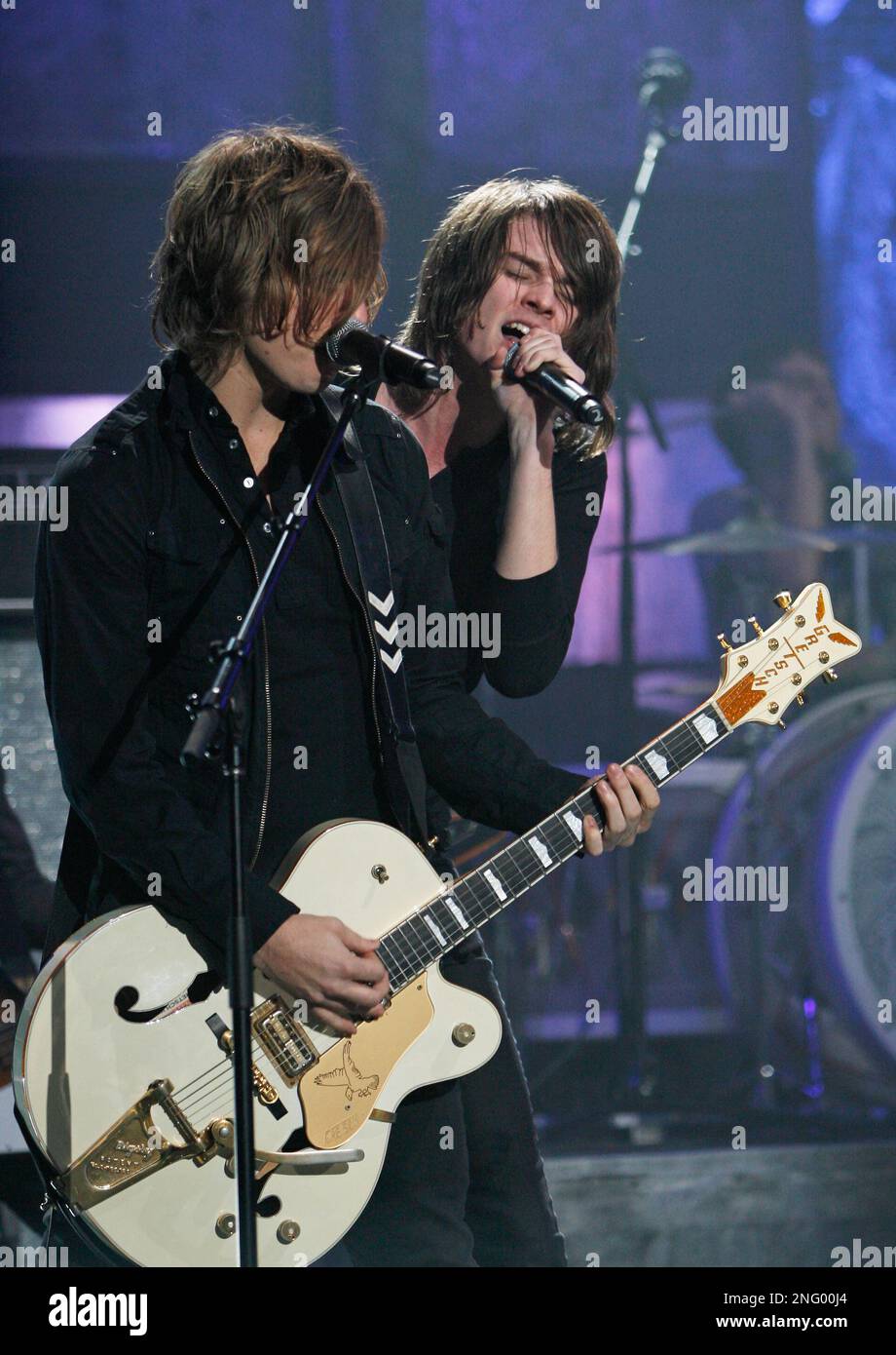 Guitarist Mike Carden, left, lead singer William Beckett, right, and ...