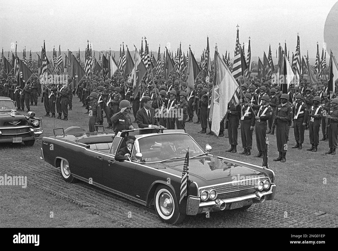 President John F. Kennedy rides with Maj. Gen. John Pugh during ...