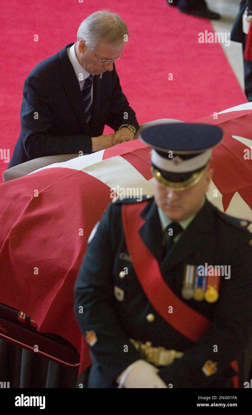 Liberal leader Stephane Dion kneels as he pays his respects to former ...