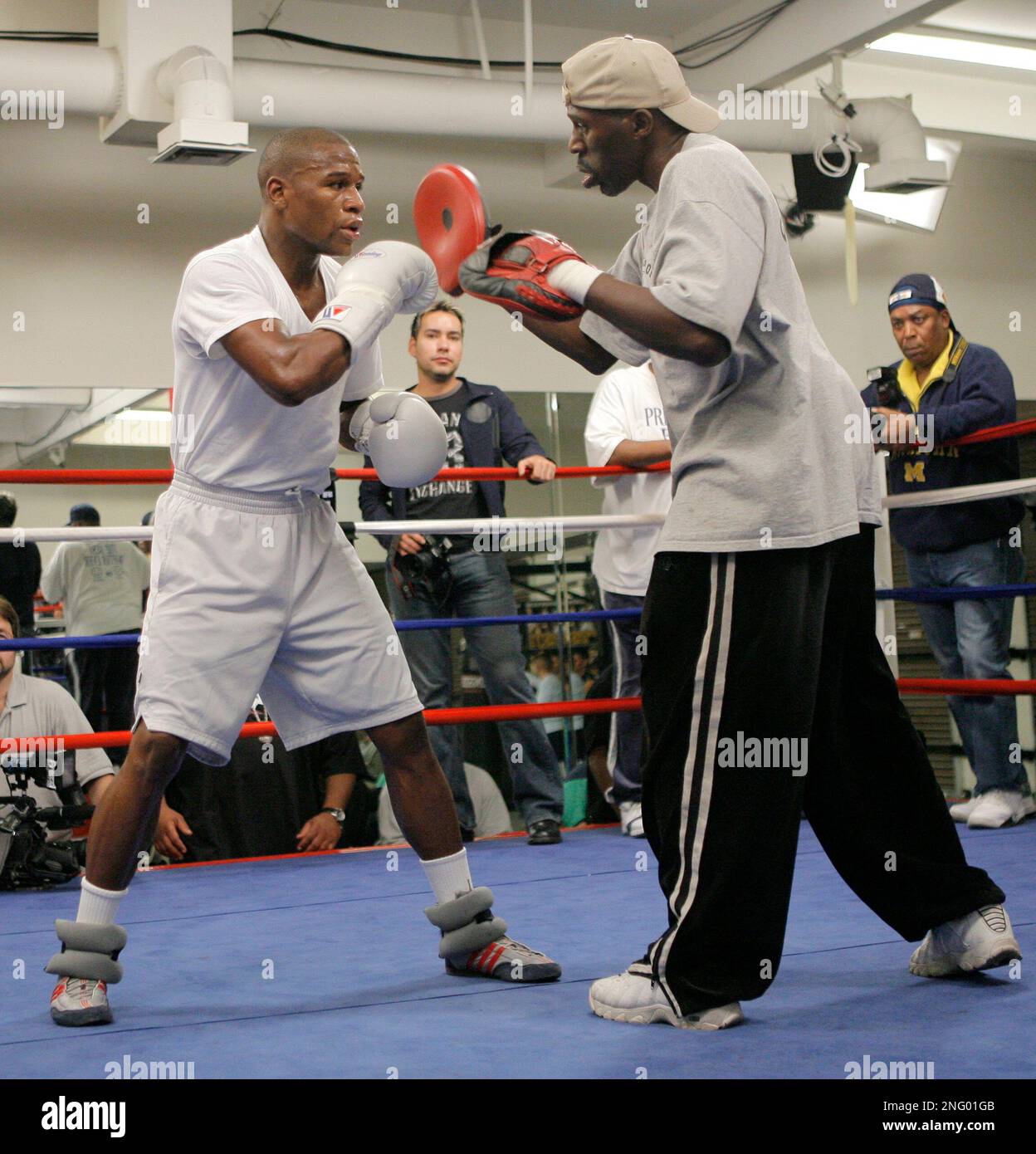 Boxer Floyd Mayweather Jr., left, trains with his uncle Roger ...