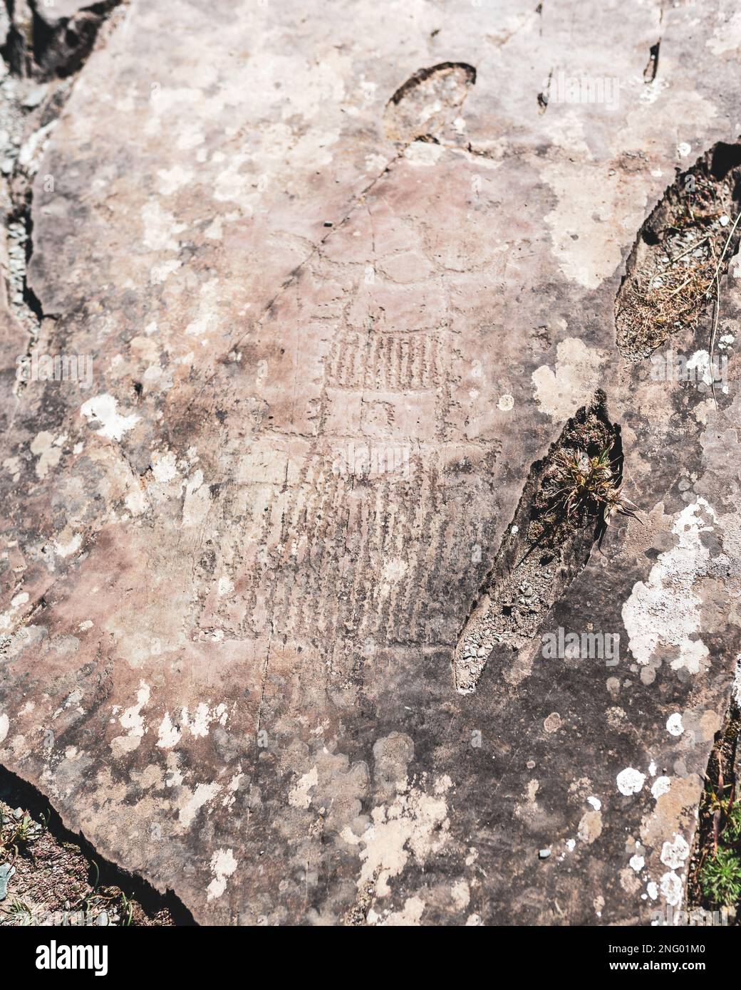 Petroglyphs rock drawing of ancient spaceship people on stones in the ...
