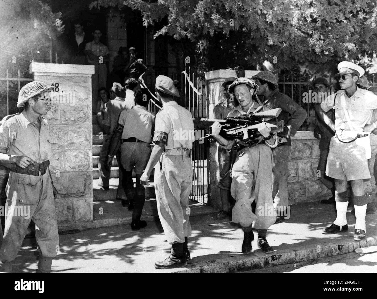 An Israeli soldier carries out arms to a waiting truck from the armoury ...