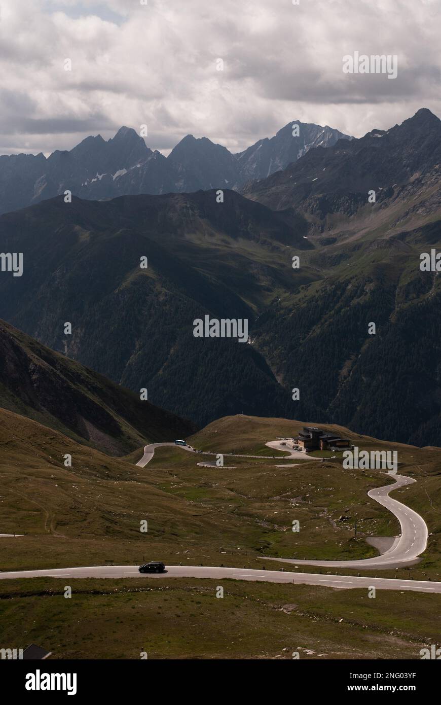 Mountains in Alps with roads and hills Stock Photo - Alamy