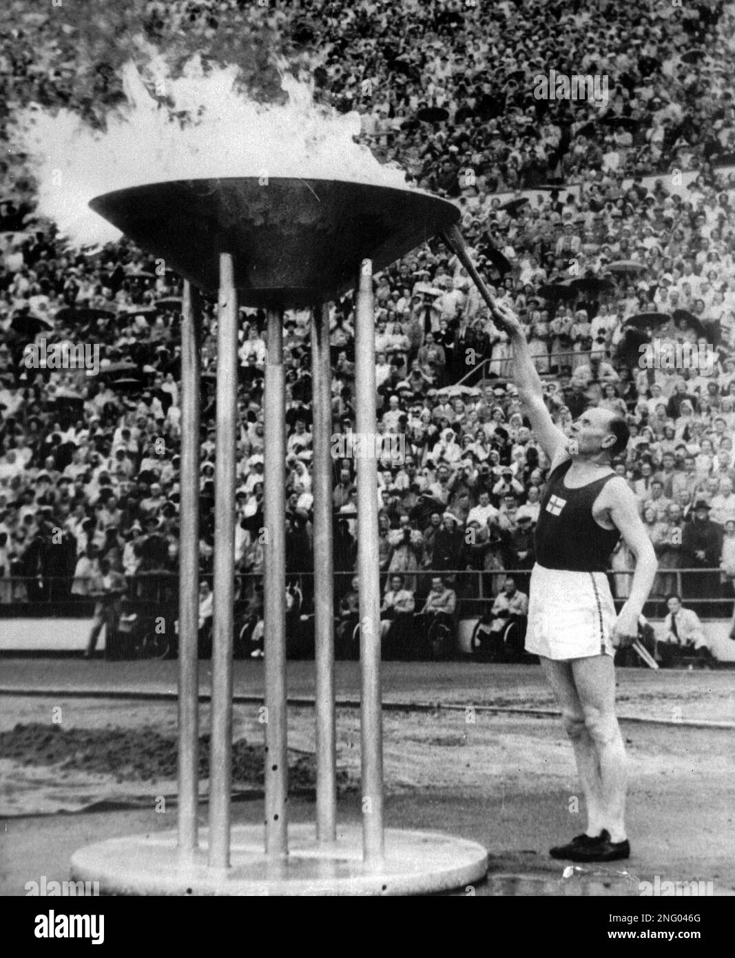 The famous Finnish runner, Paavo Nurmi, lights the Olympic flame from ...
