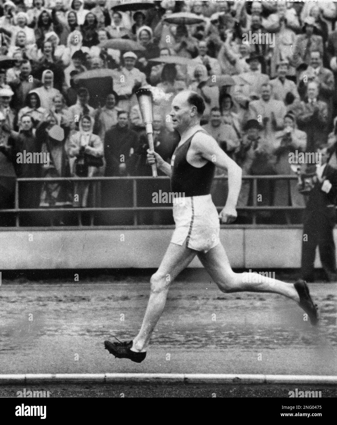Paavo Nurmi, the "Flying Finn" carries the Olympic flame during the ...