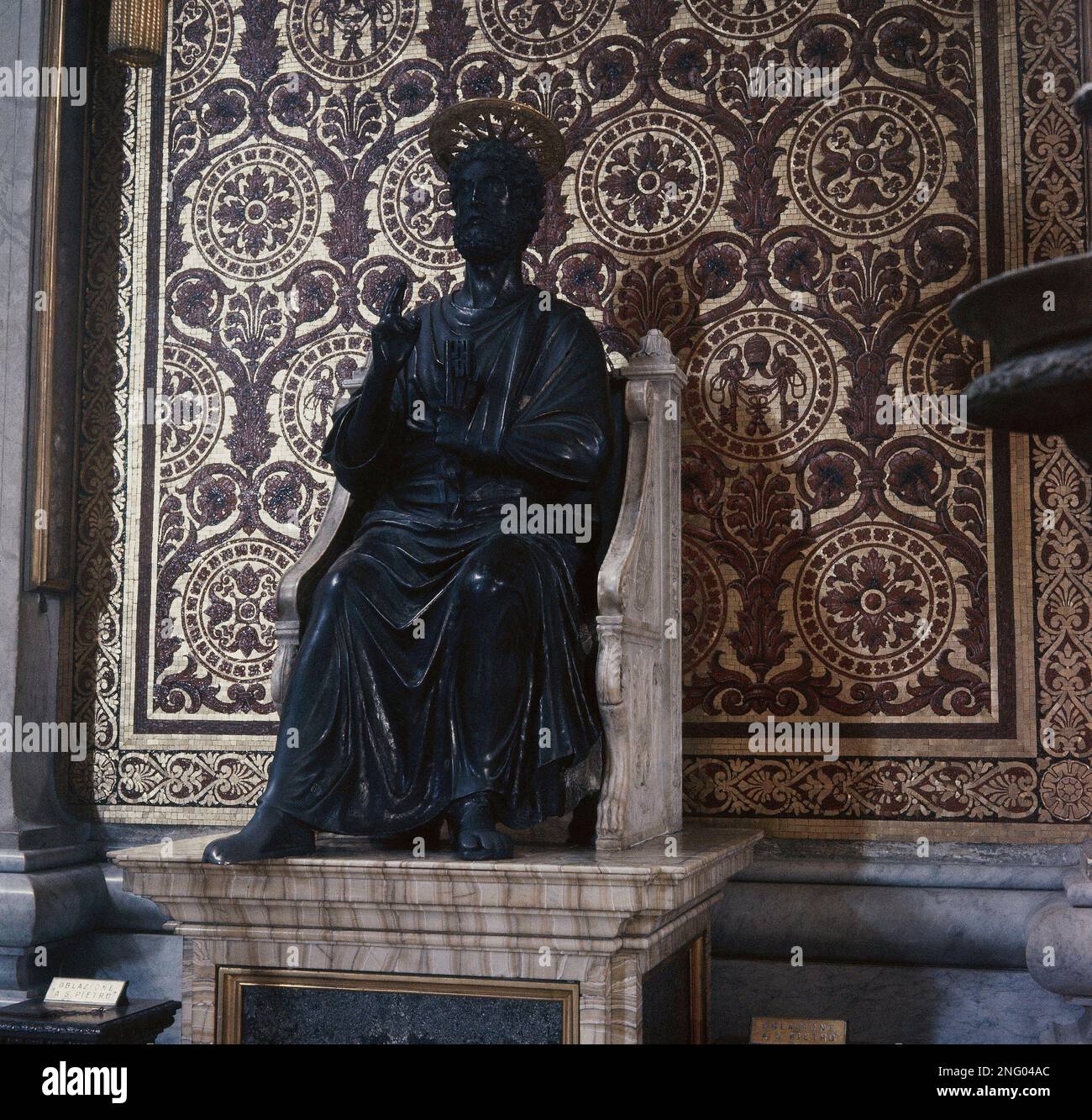 Seen here is the famous bronze statue of St. Peter, sitting on a white ...