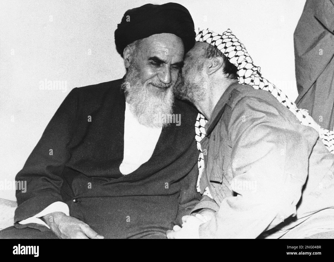 Palestine guerilla leader Yasser Arafat gives a kiss to Ayotolla ...