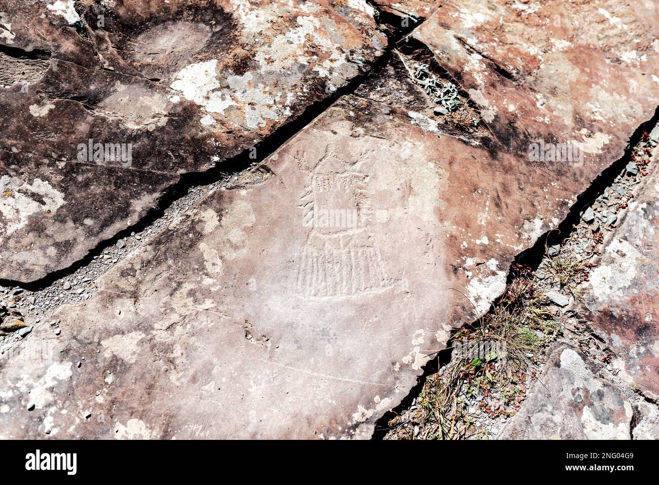 Petroglyphs rock drawing of ancient people of an unknown space flying ...
