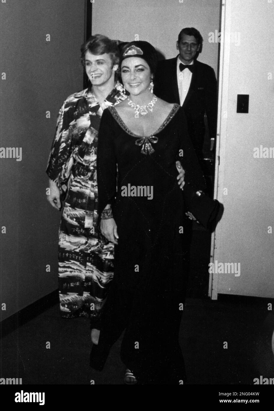 Dancer Mikhail Baryshnikov, left, and actress Elizabeth Taylor enter ...
