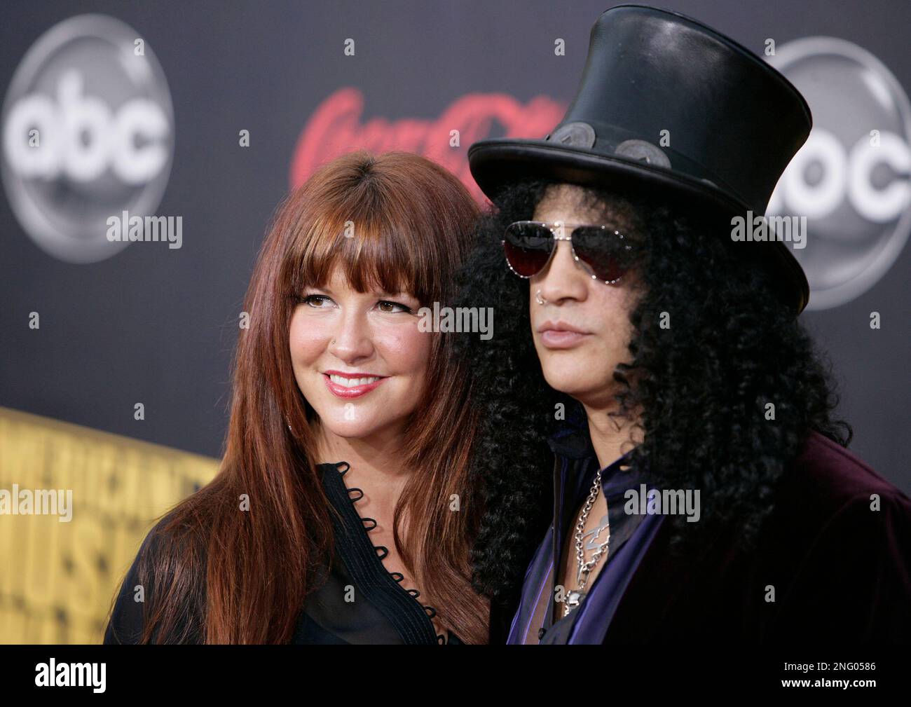 Perla Ferrar, left, and guitarist Slash arrive at the American Music ...
