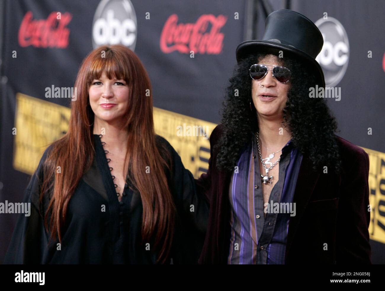 Perla Ferrar, left, and guitarist Slash arrive at the American Music ...