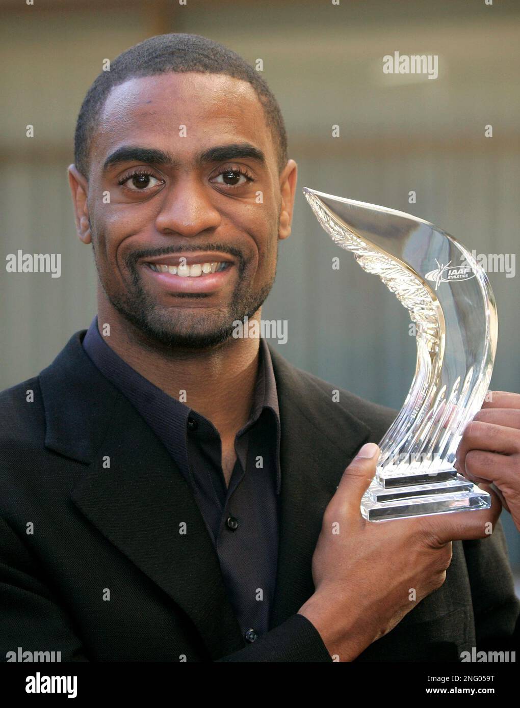 U.S World champion Tyson Gay holds his "Athlete of the Year Award ...
