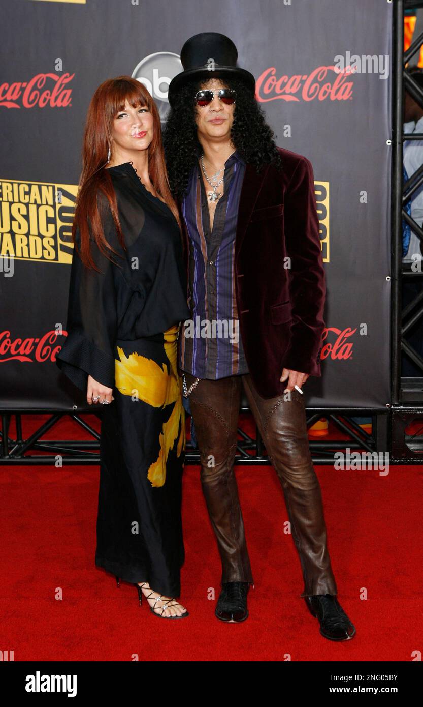 Perla Ferrar, left, and guitarist Slash arrive at the American Music ...