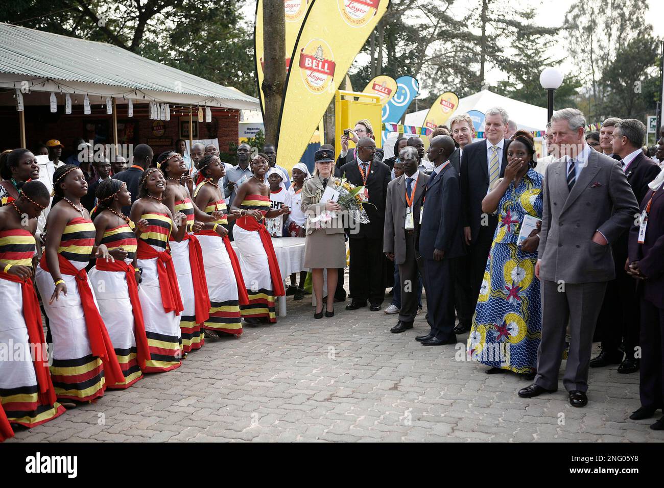 Britain's Prince Charles looks to Ugandan children as they sing and ...