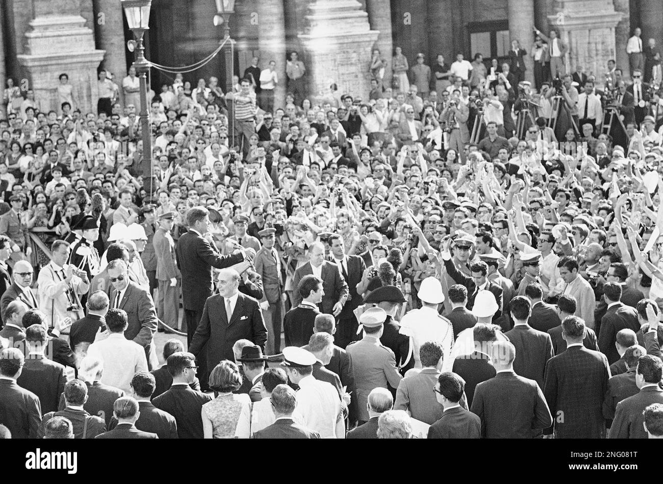 Romans wave to cheer U.S. President John Kennedy as he makes a brief ...