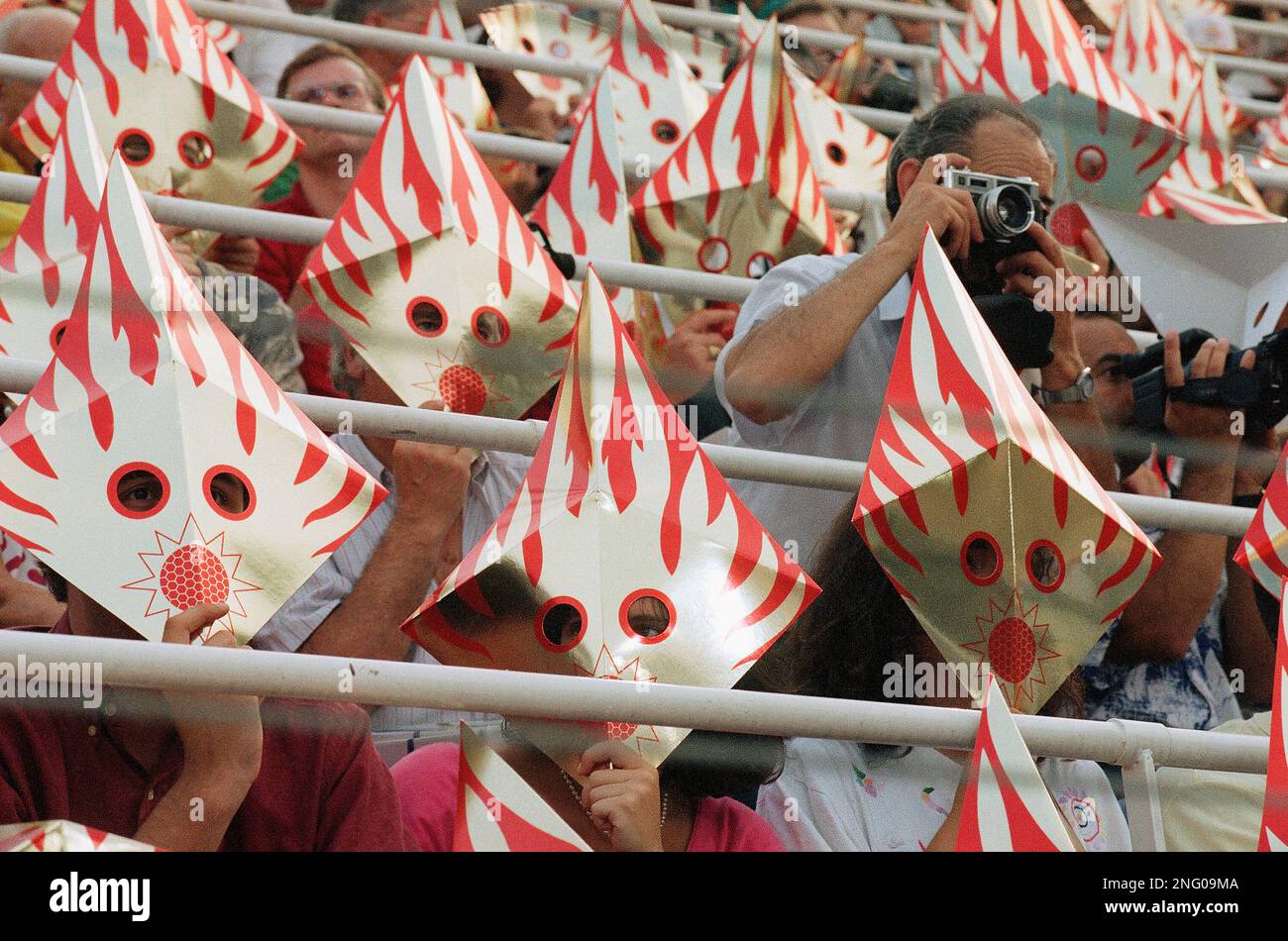 Spectators wear sun masks during the opening ceremonies of the XXV ...