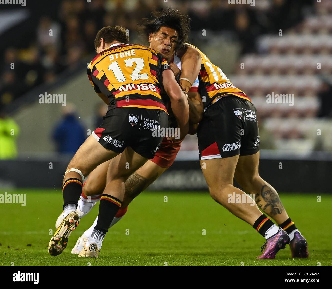 Tom Amone #8 of Leigh Leopards is tackled by James Greenwood #12 and ...