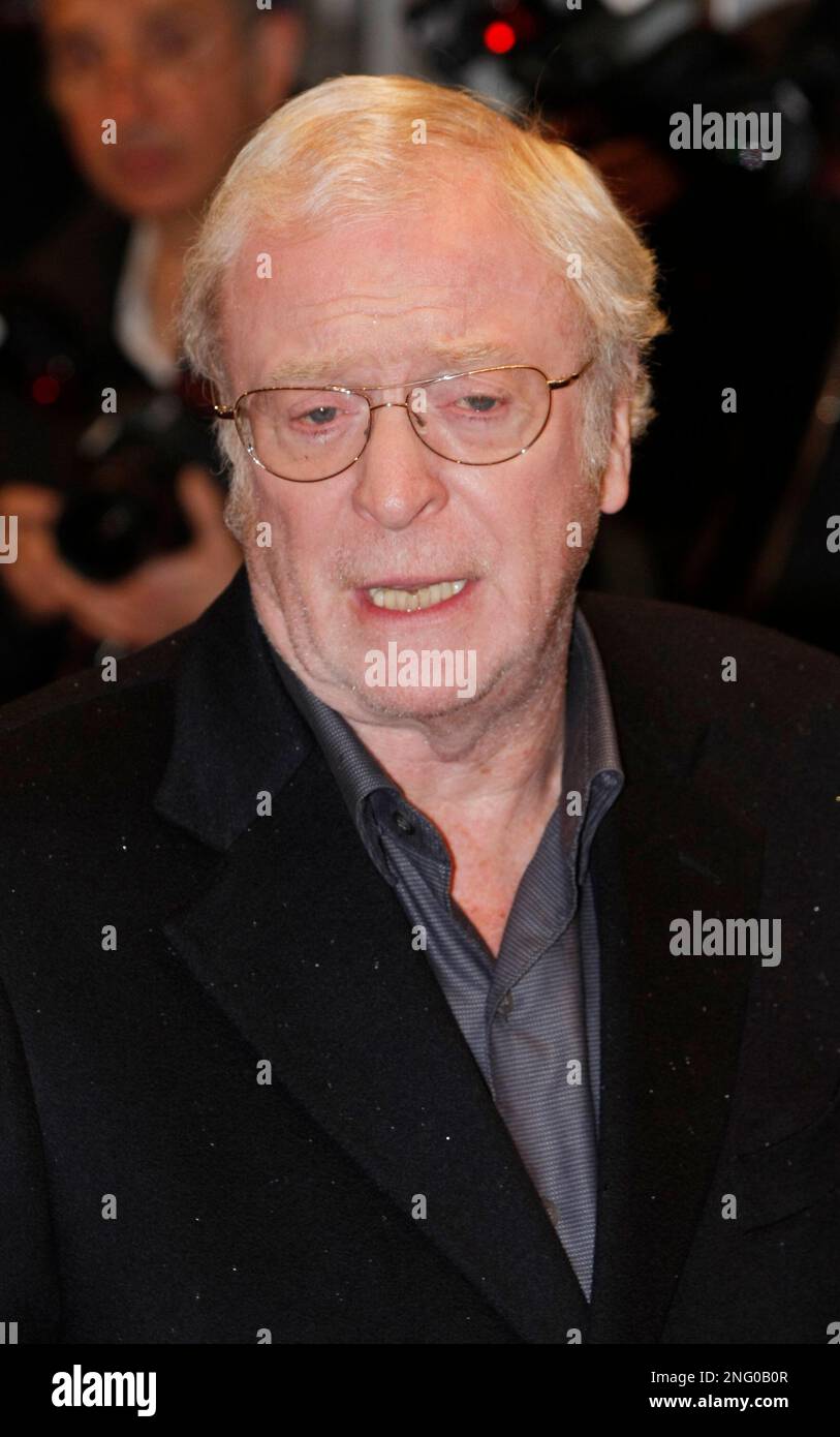 British actor Michael Caine poses for photographs as he arrives for the ...