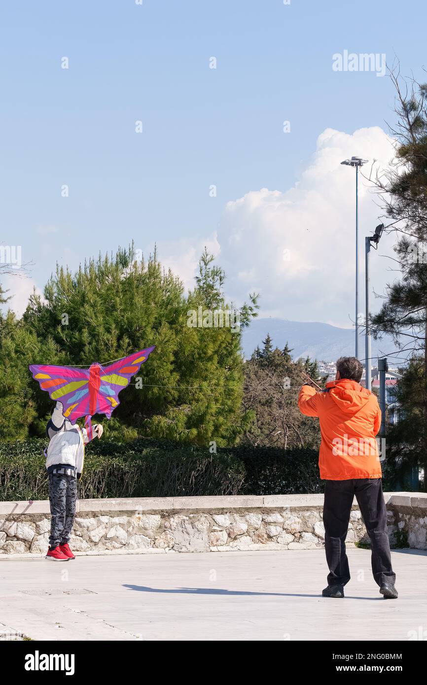 Father and son flying a kite into the sky. Blue sky. Sports kite ...