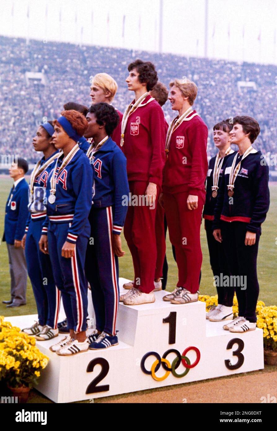 The first three teams in women's 400 meter relay stand on the podium ...