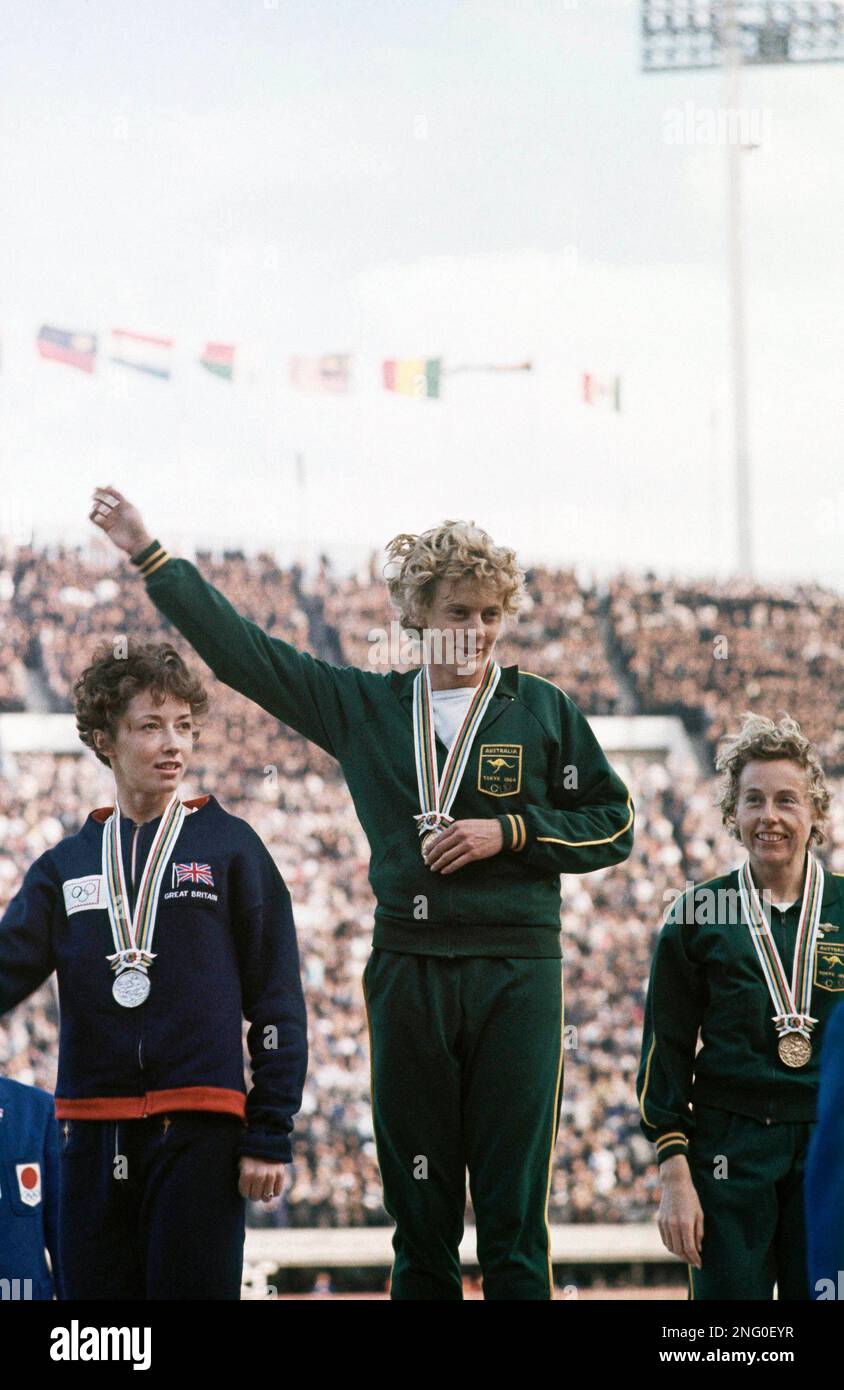 Betty Cuthbert of Australia waves a greeting after receiving her gold ...