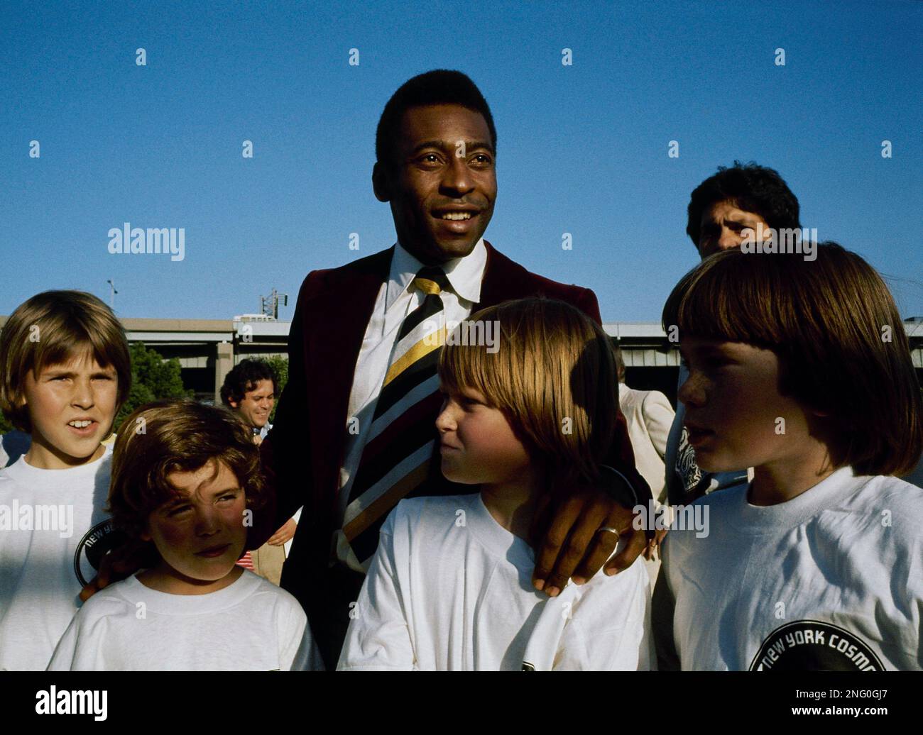 Pictured here is Brazilian soccer player Pele with a group of young ...