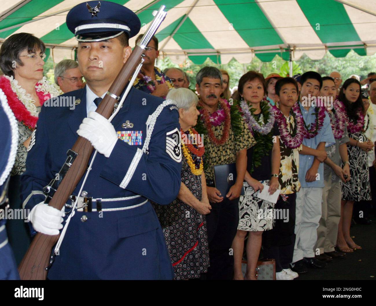 Hawaii Governor Linda Lingle (left) stands next to the Okutsu family on ...