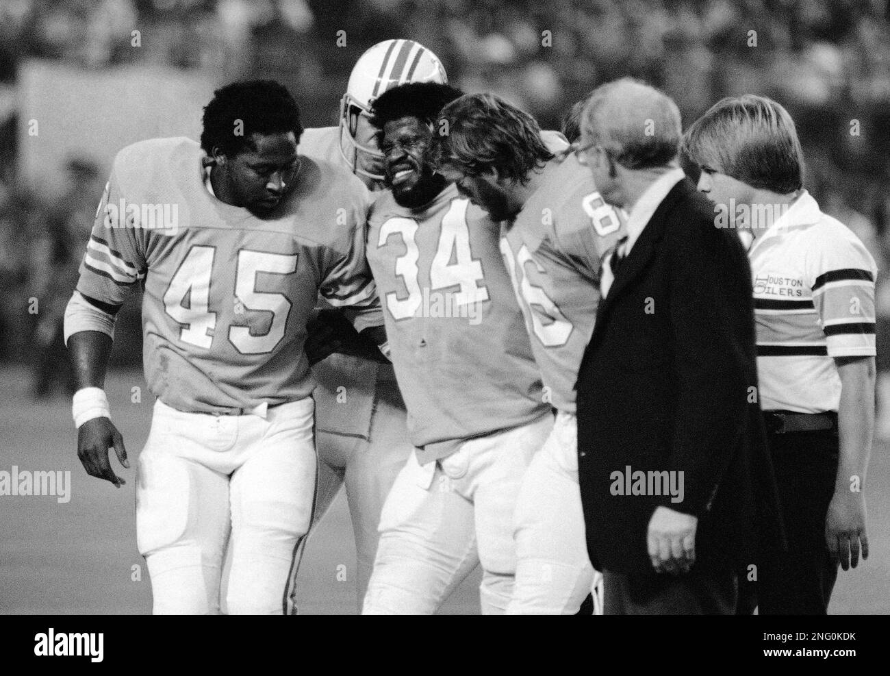 Houston Oilers' running back Earl Campbell (34) in pain as he held from ...