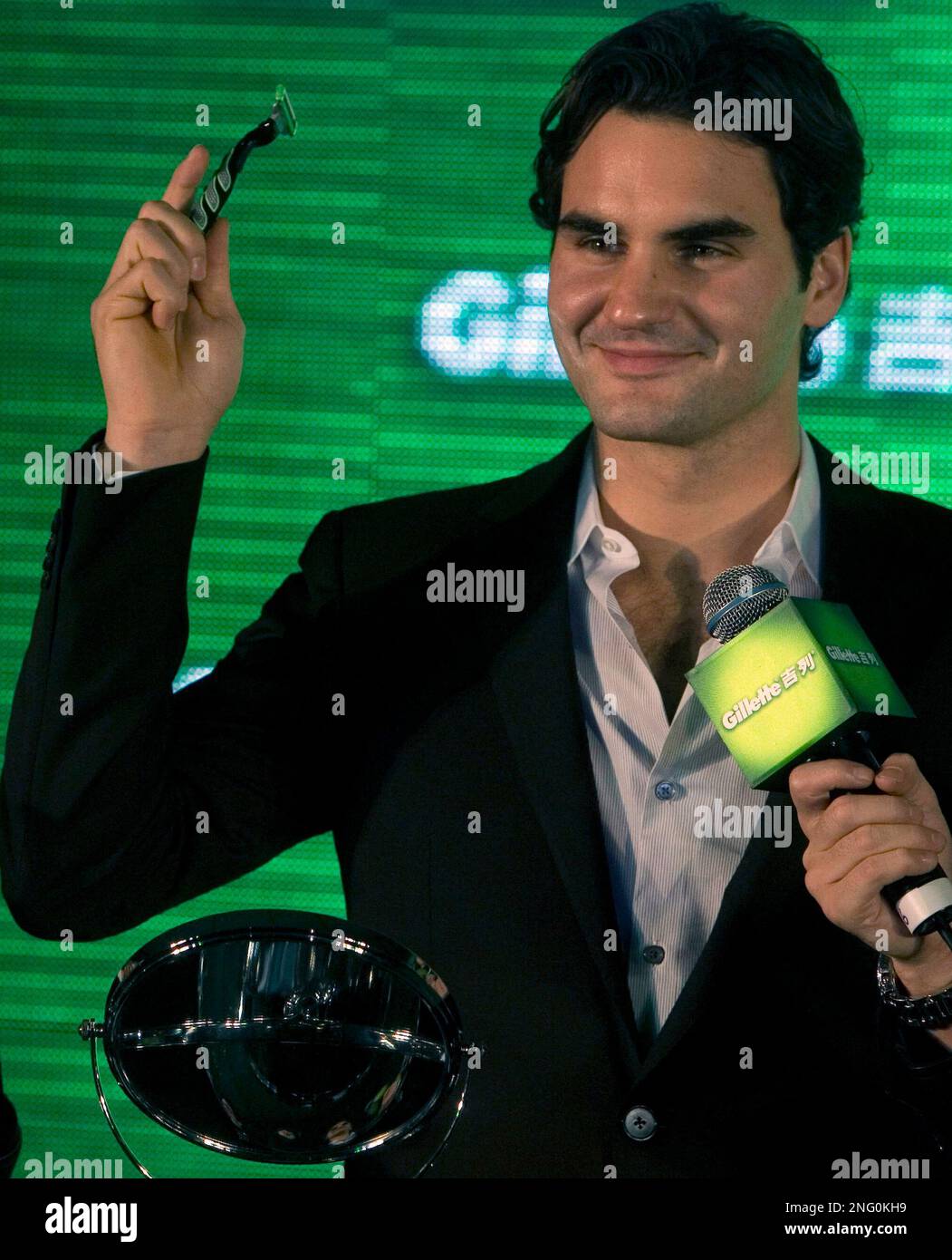 Tennis player Roger Federer holds a Gillette razor during a promotional ...