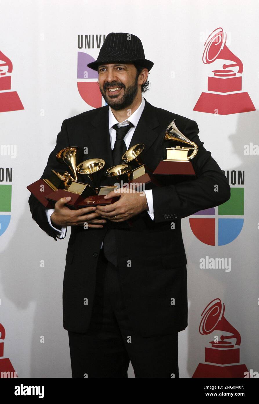 Juan Luis Guerra poses with his five Grammy awards backstage at the 8th ...
