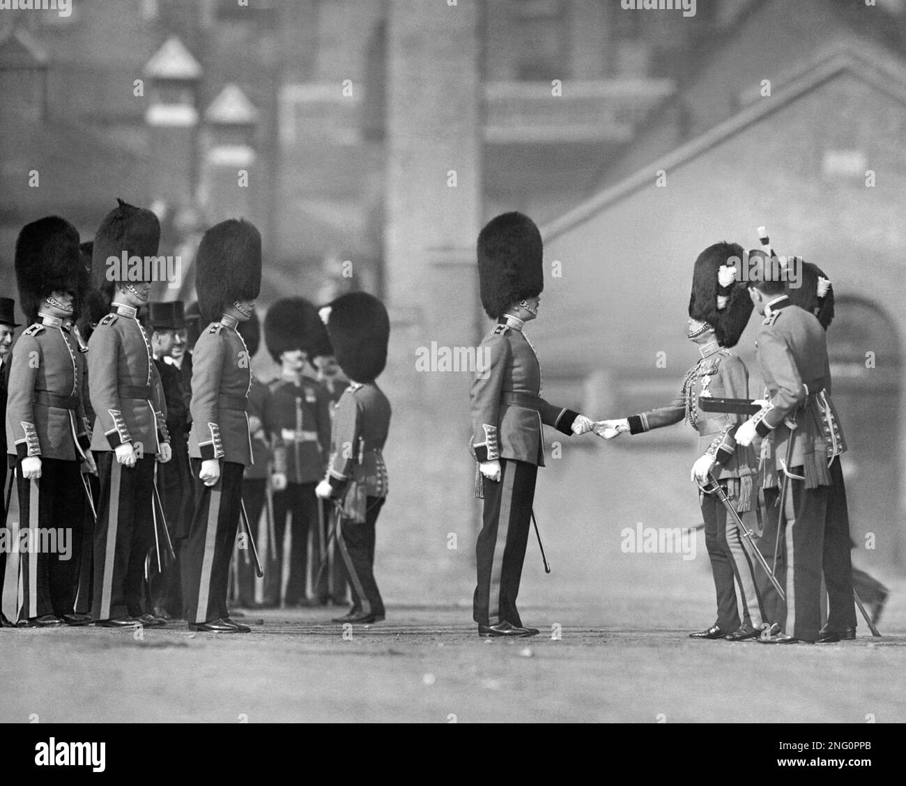 An officer of the Welsh Guards, centre, receives a leek from the Prince ...