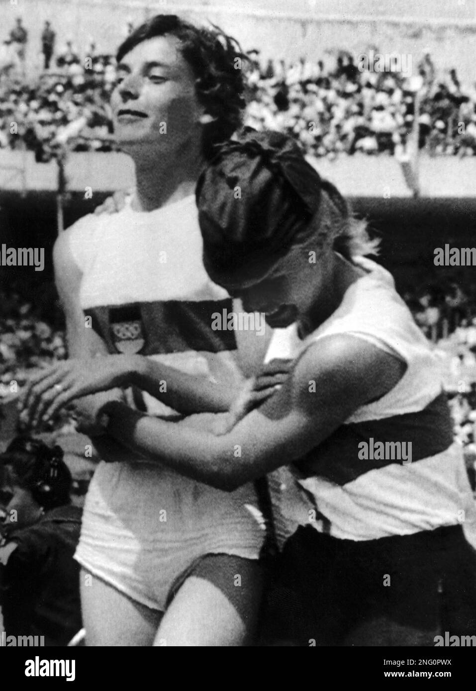 West German athlete Ingrid Mickler-Becker, left, enjoys her victory ...