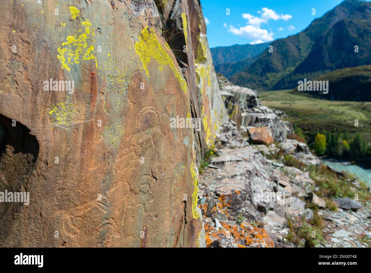 Petroglyphs rock drawings of ancient people animal deer on bright ...