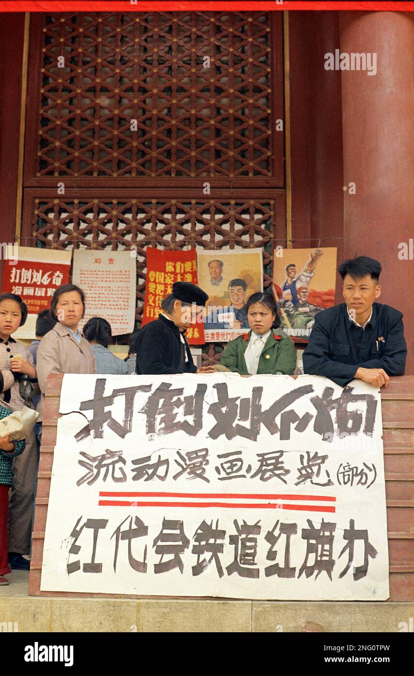 Chinese stand among signs and posters during May Day activities in ...