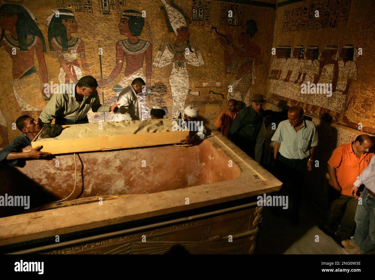 The linen-wrapped mummy of King Tut is moved from his stone sarcophagus ...