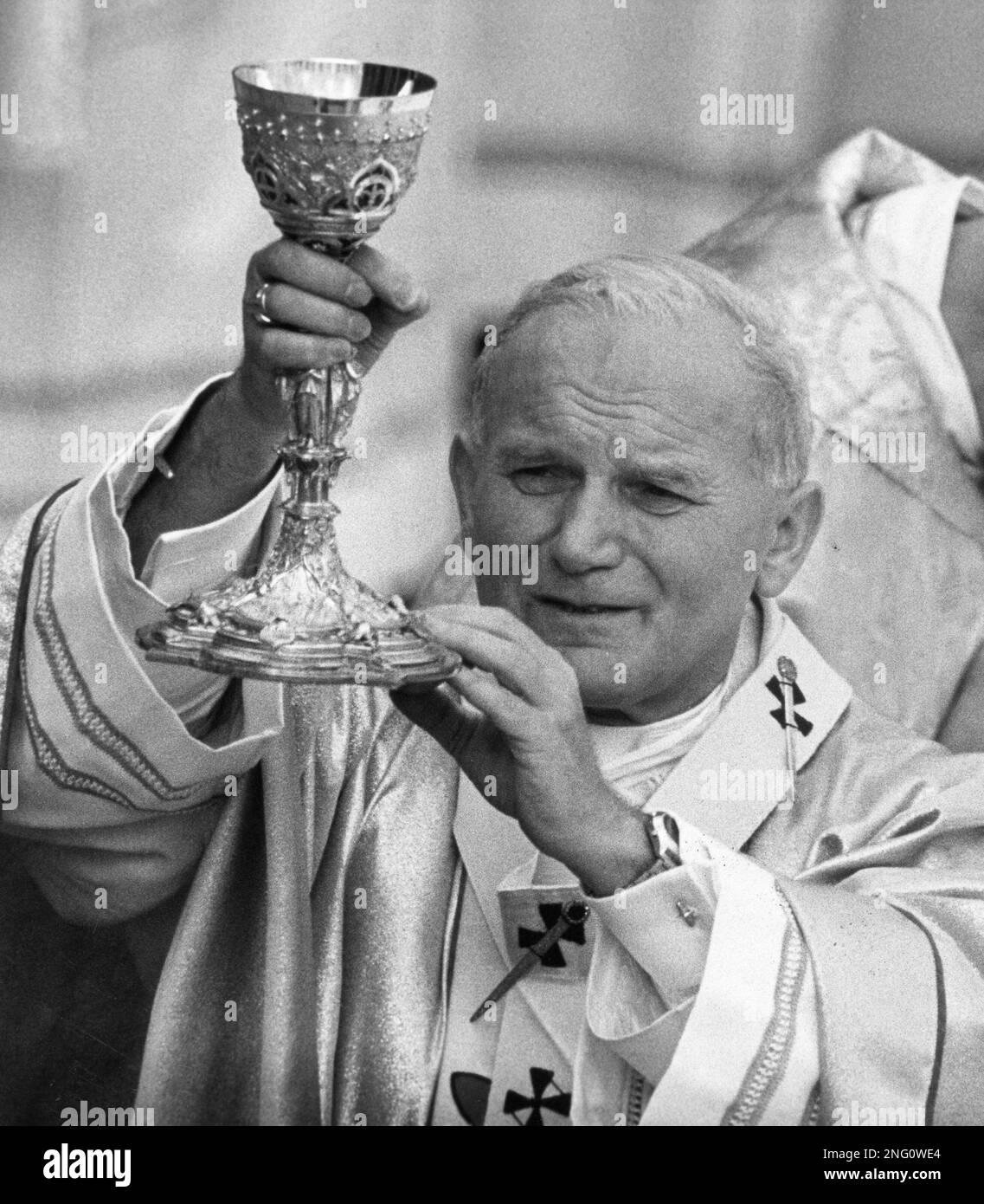 Pope John Paul II raises the calyx during a mass held at St. Peter's ...