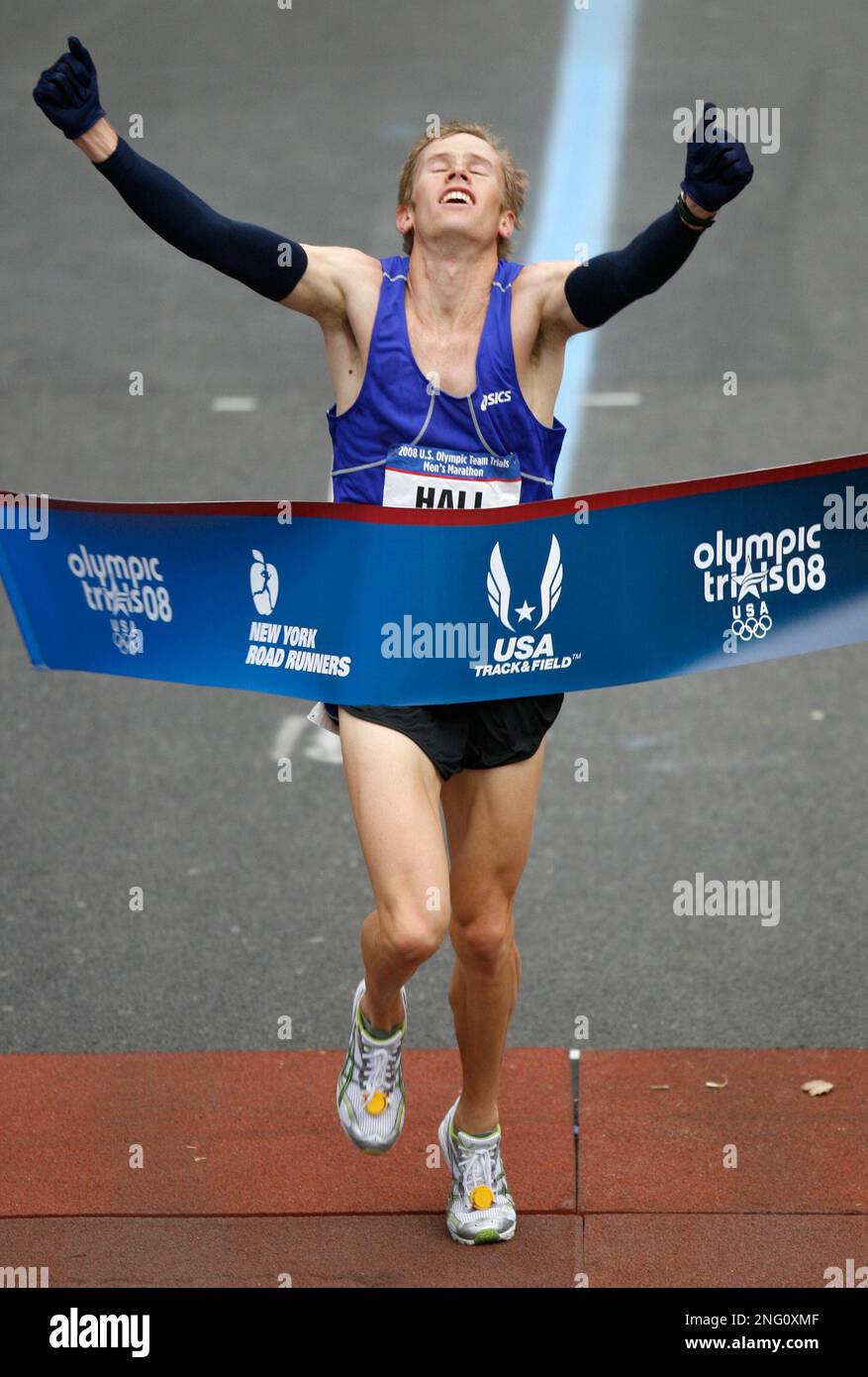 Ryan Hall, of Big Bear Lake, Calif., crosses the finish line to place ...