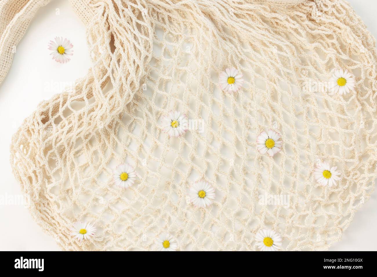 Reusable shopping mesh bag on white with flowers background. Zero waste ...