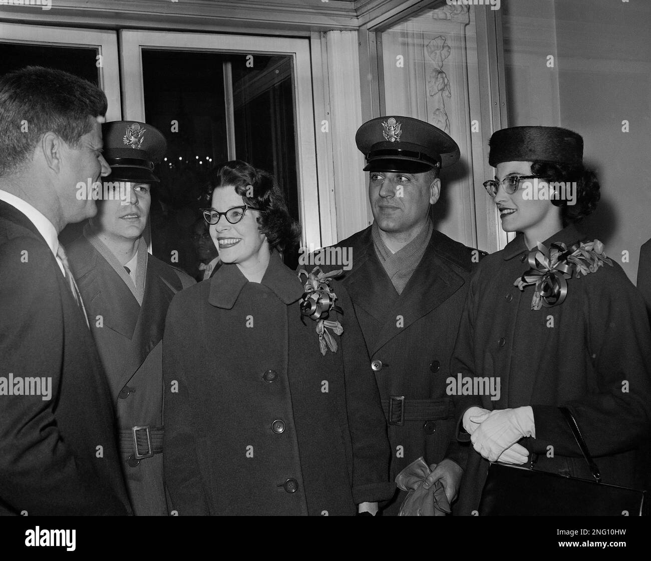 President John Kennedy greets two US Air Force fliers and their wives ...