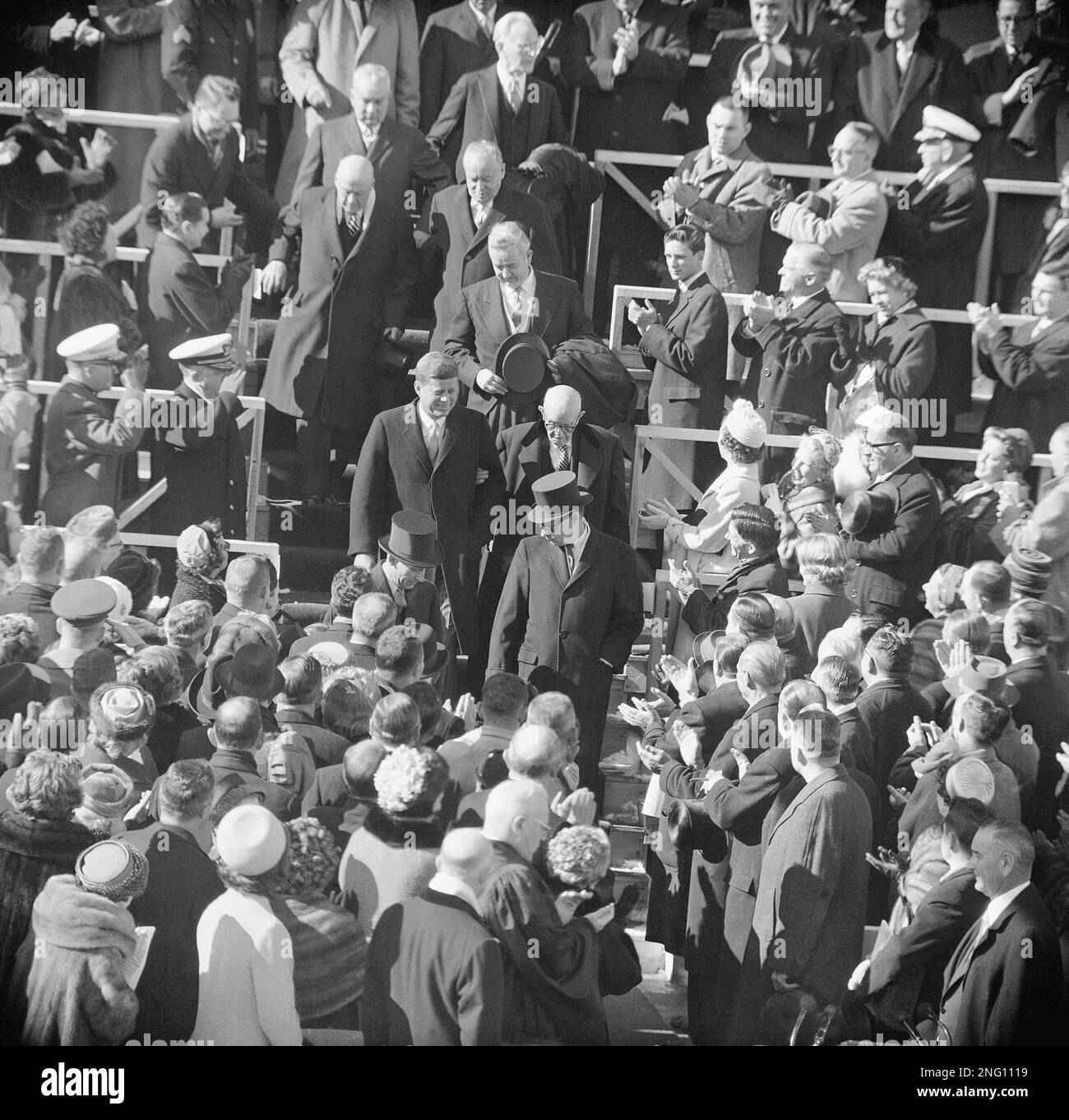 John F. Kennedy, hatless upper left, is escorted through crowd as ...