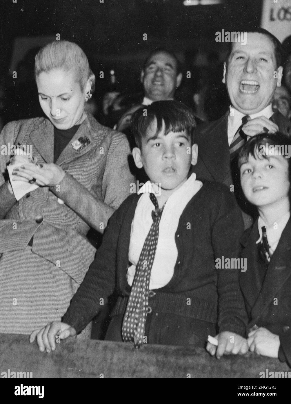 Eva Peron signs autographs for youngsters as her husband, Argentine ...