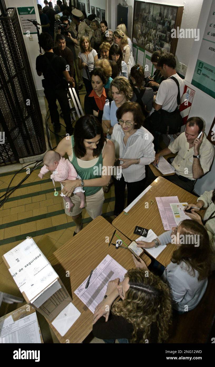People wait in line to cast their vote during Argentina's presidential ...