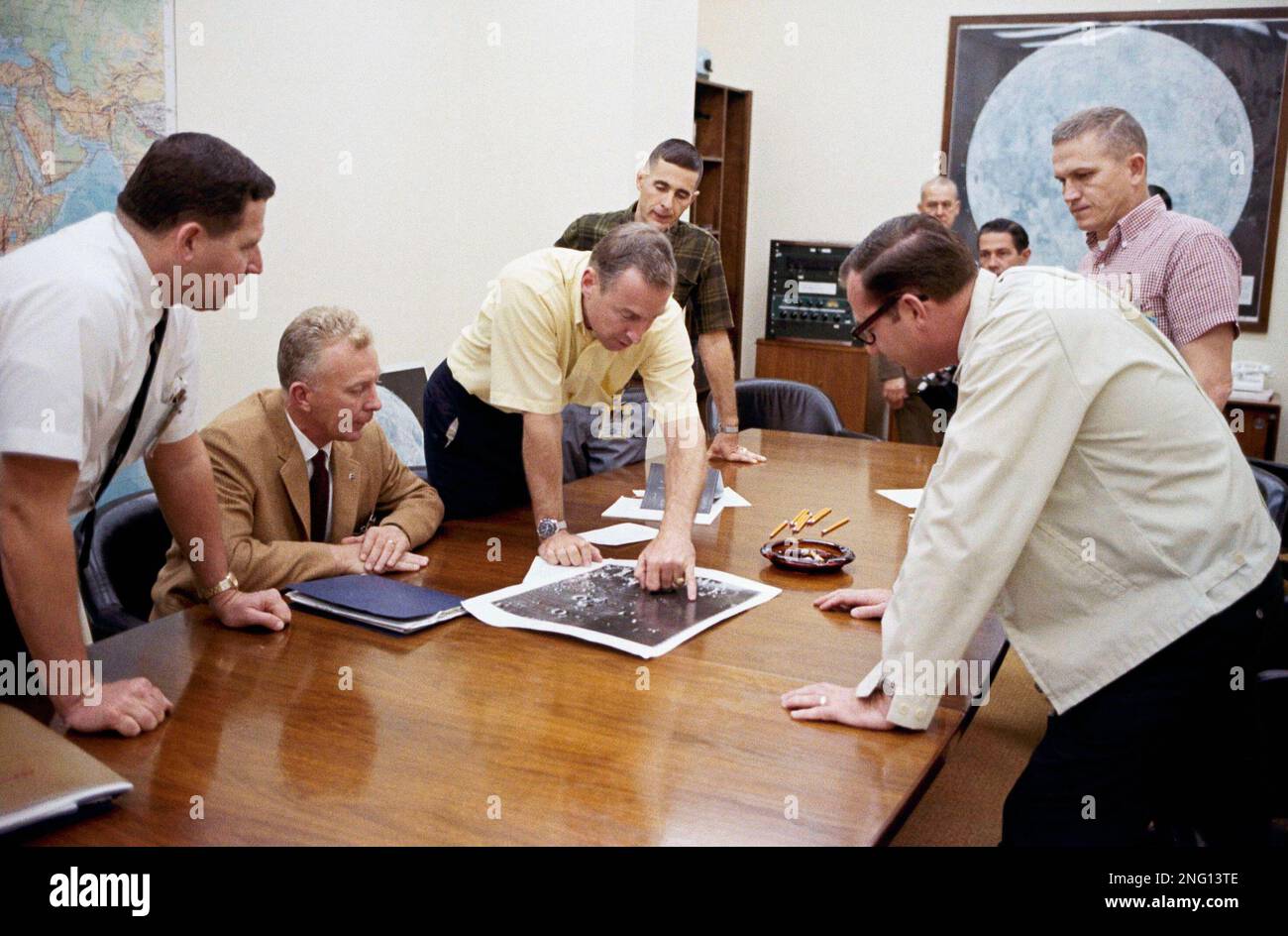 Apollo 8 command module pilot James Lovell points to a map of lunar ...
