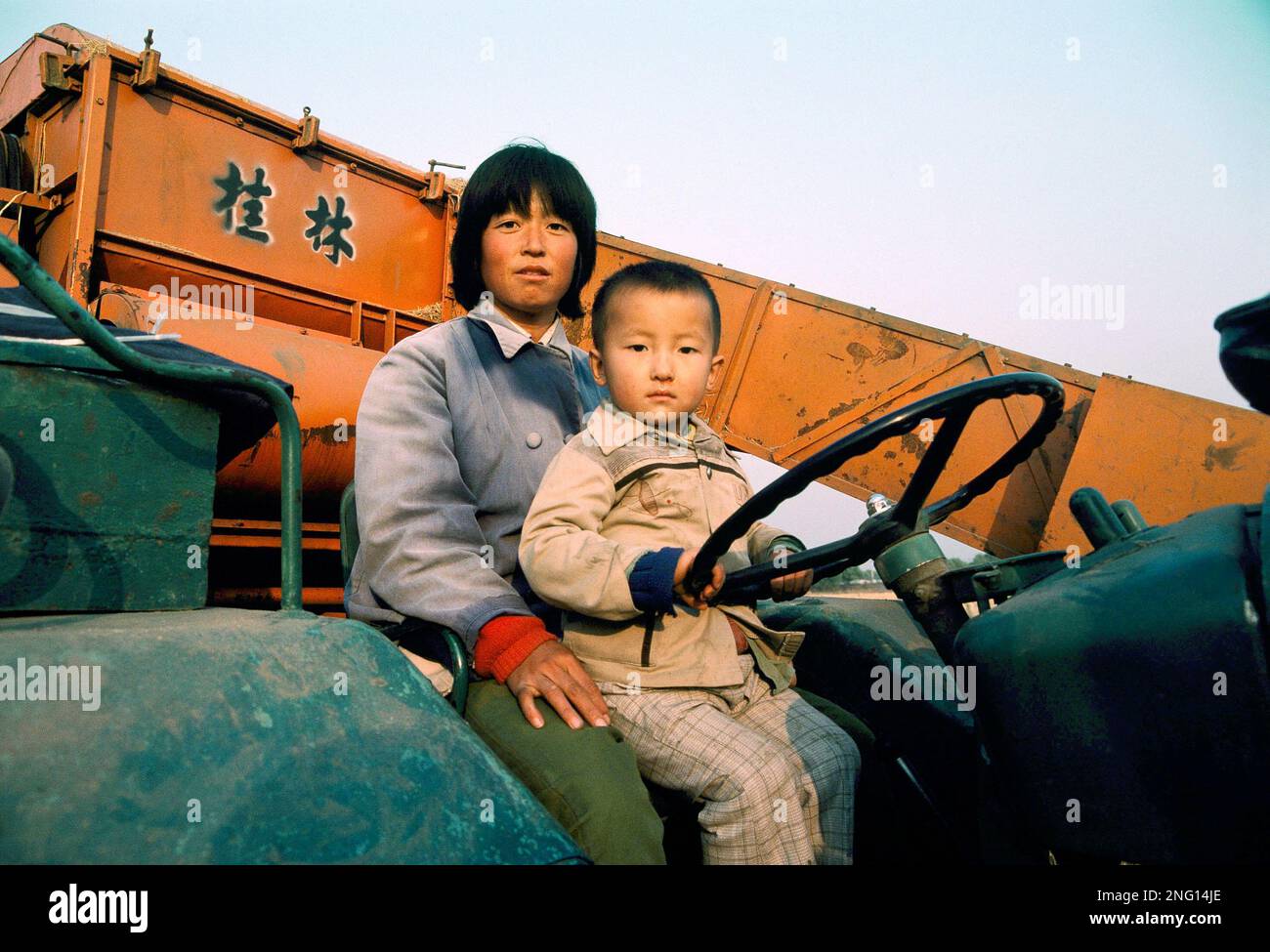 Farmer and child harvesting field in Beijing, China, November 1, 1985 ...