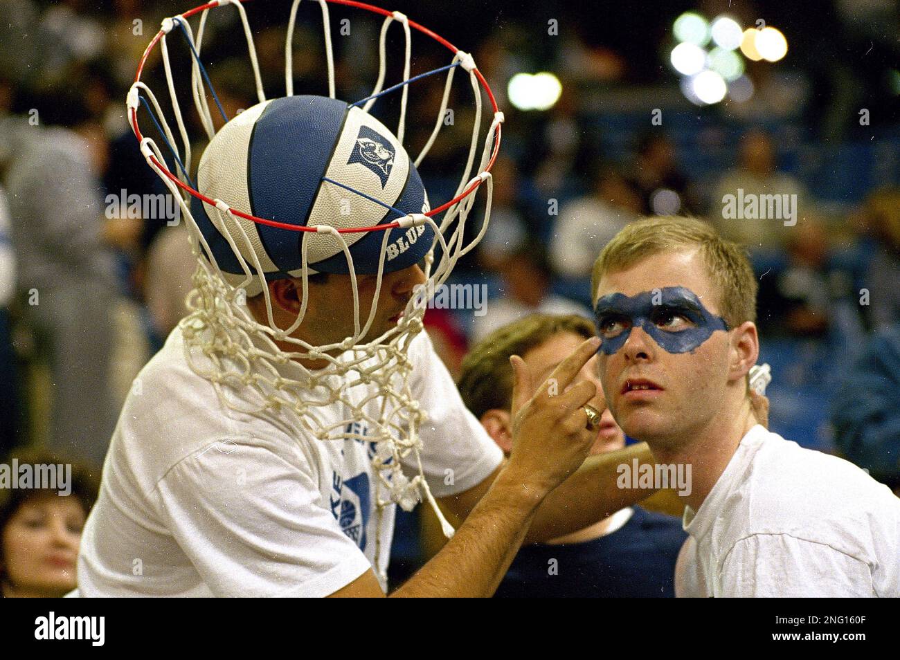 Duke senior Dave Ice manages to see though the net and basketball he ...