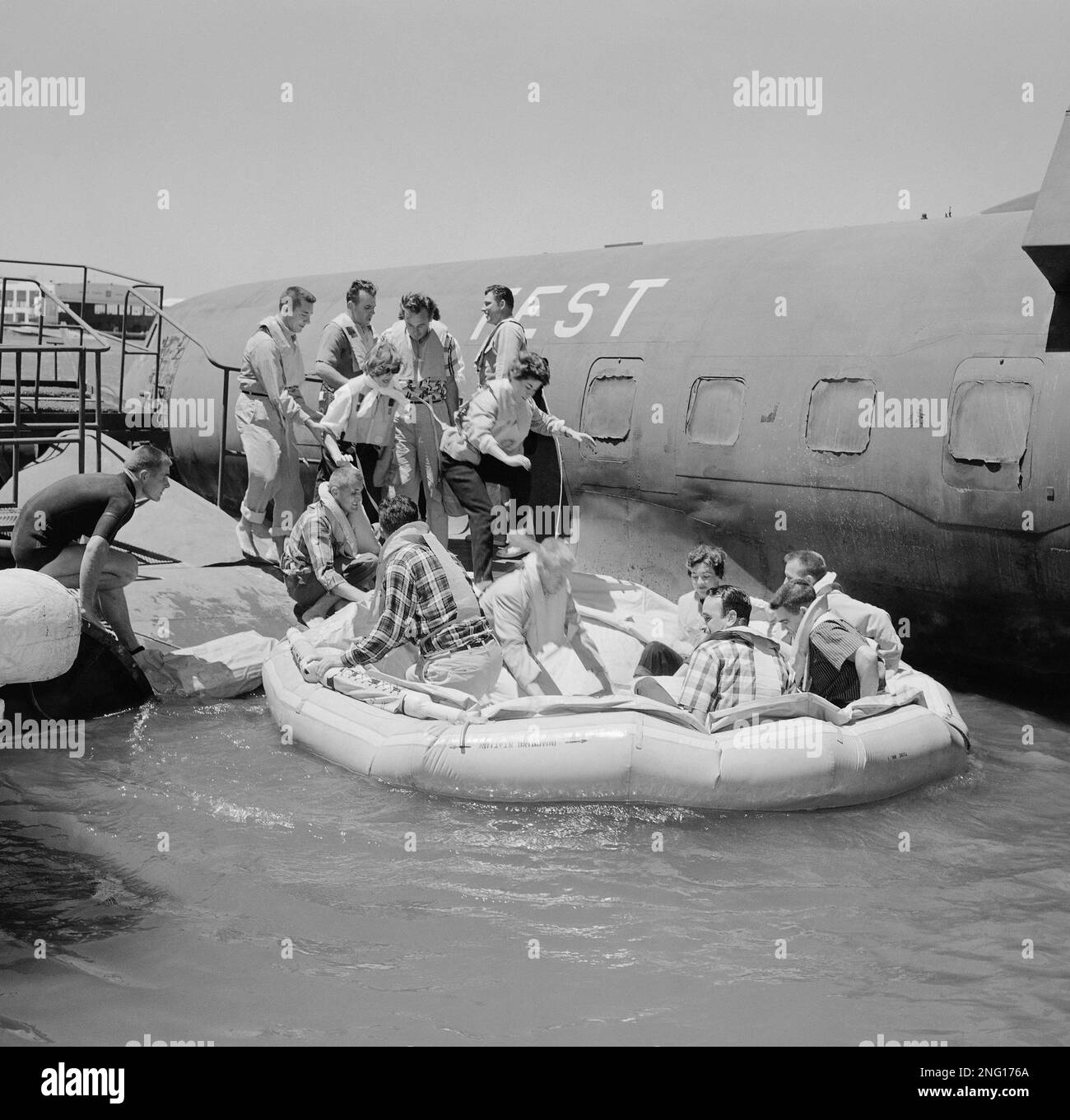 Flight crew members jump from the wing of a plane during a recent wet ...