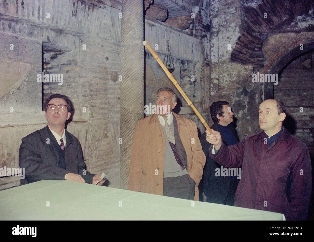 Unidentified guide shows tourists through Catacombs of St. Calixtus ...