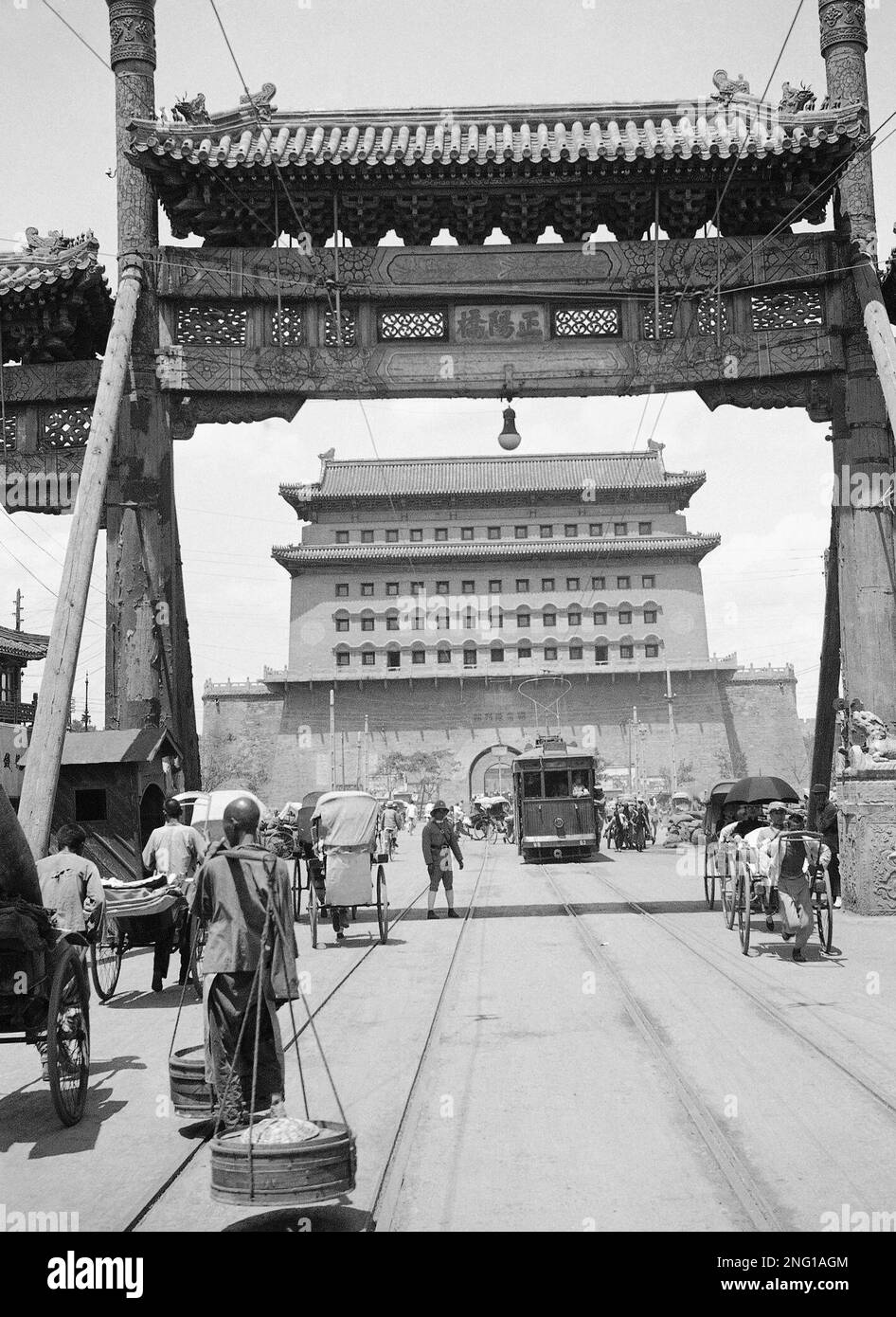 Modern street cars go under the beautiful Beijing Gateways, in the ...